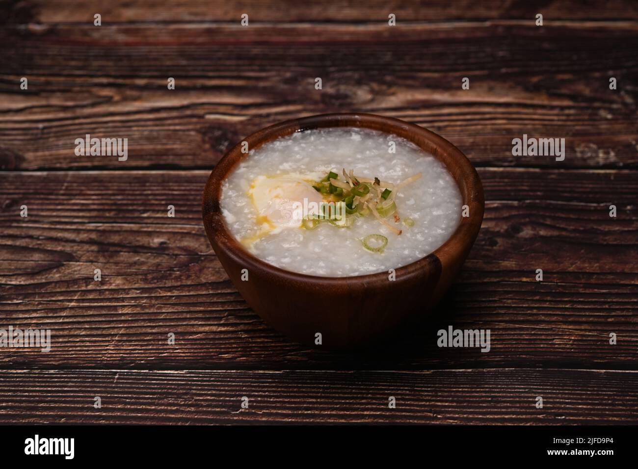 Rice porridge, rice gruel or congee with boiled egg ,sliced ginger and ...