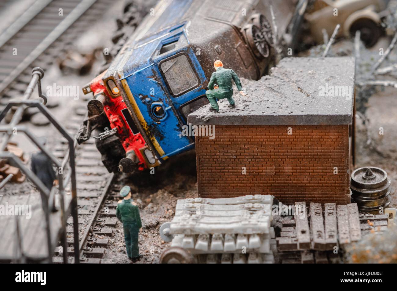 Toy representation of a derailed train Stock Photo - Alamy