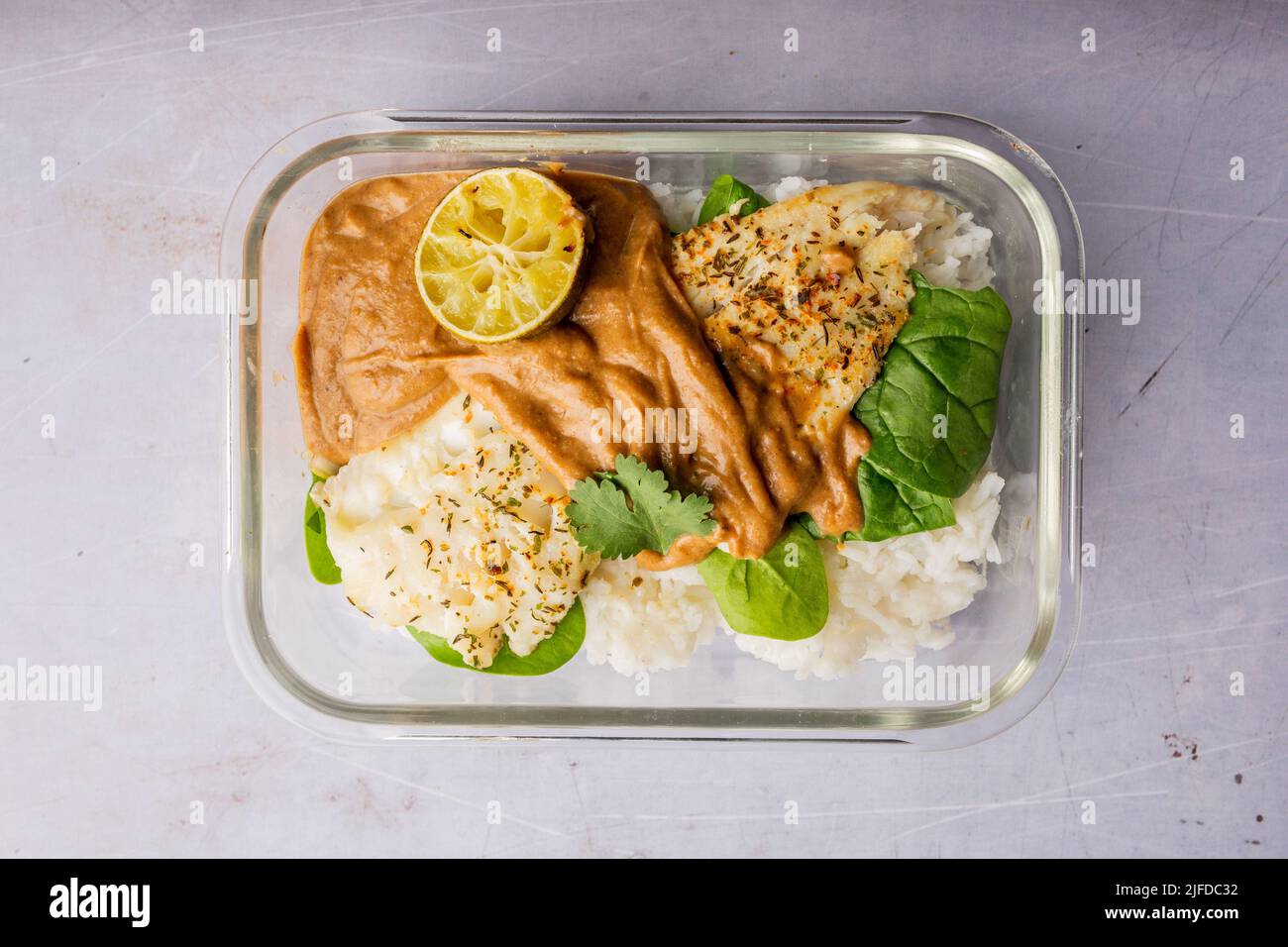 A top view of Grilled salmon bento in transparent tray for food ...