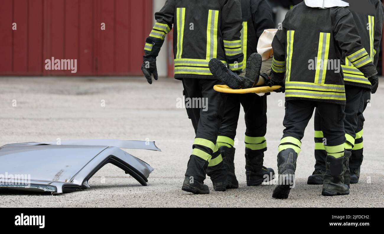 four brave firefighters and the stretcher with injured person after the ...