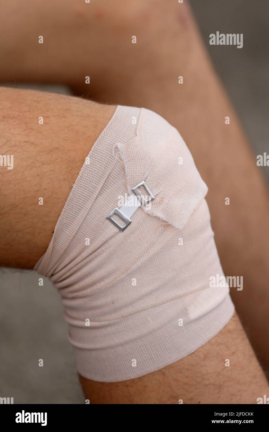 boy's knee after the sprain with an elastic band for protection of the ...