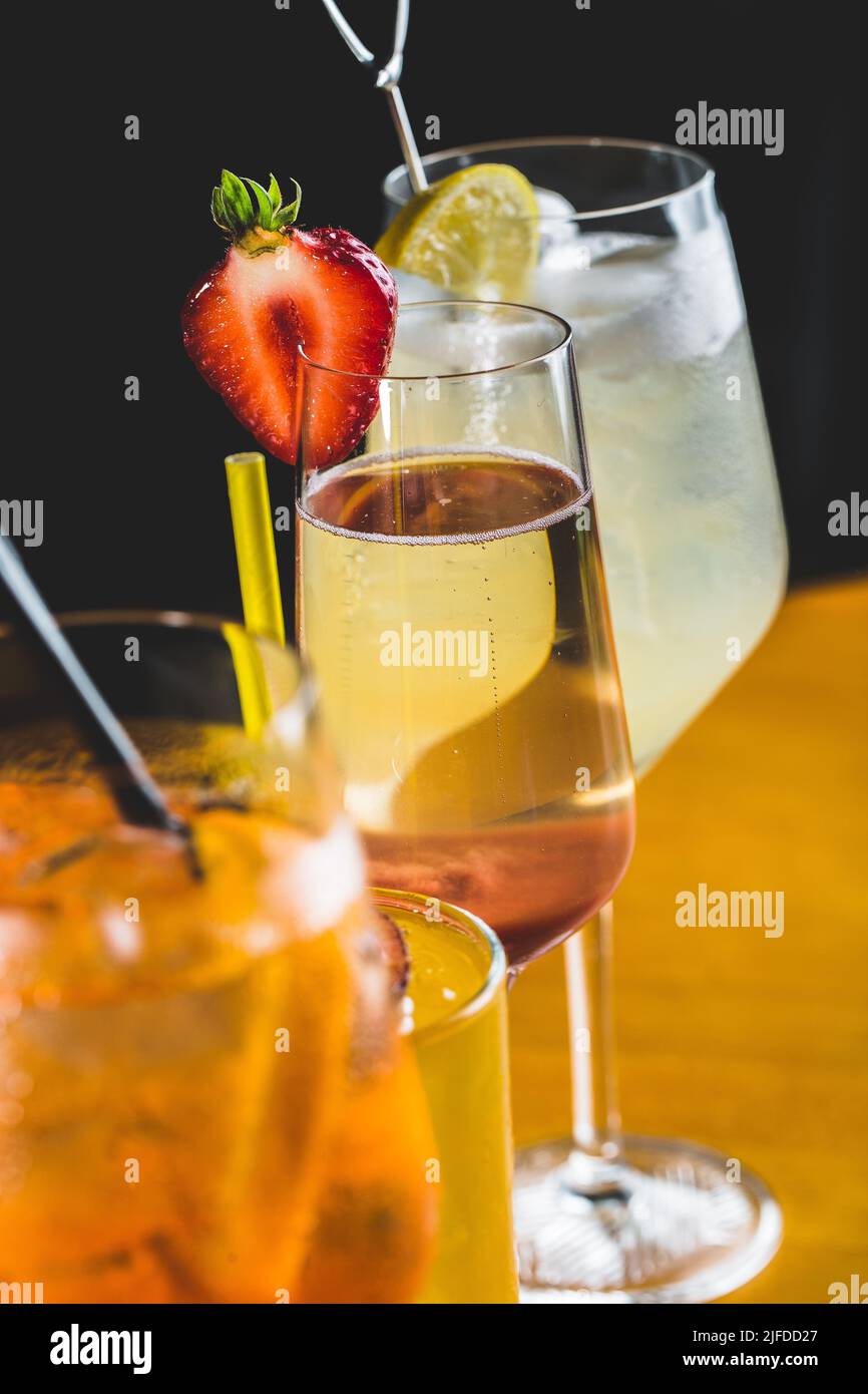A vertical closeup of glasses of cocktails on bar counter Stock Photo ...