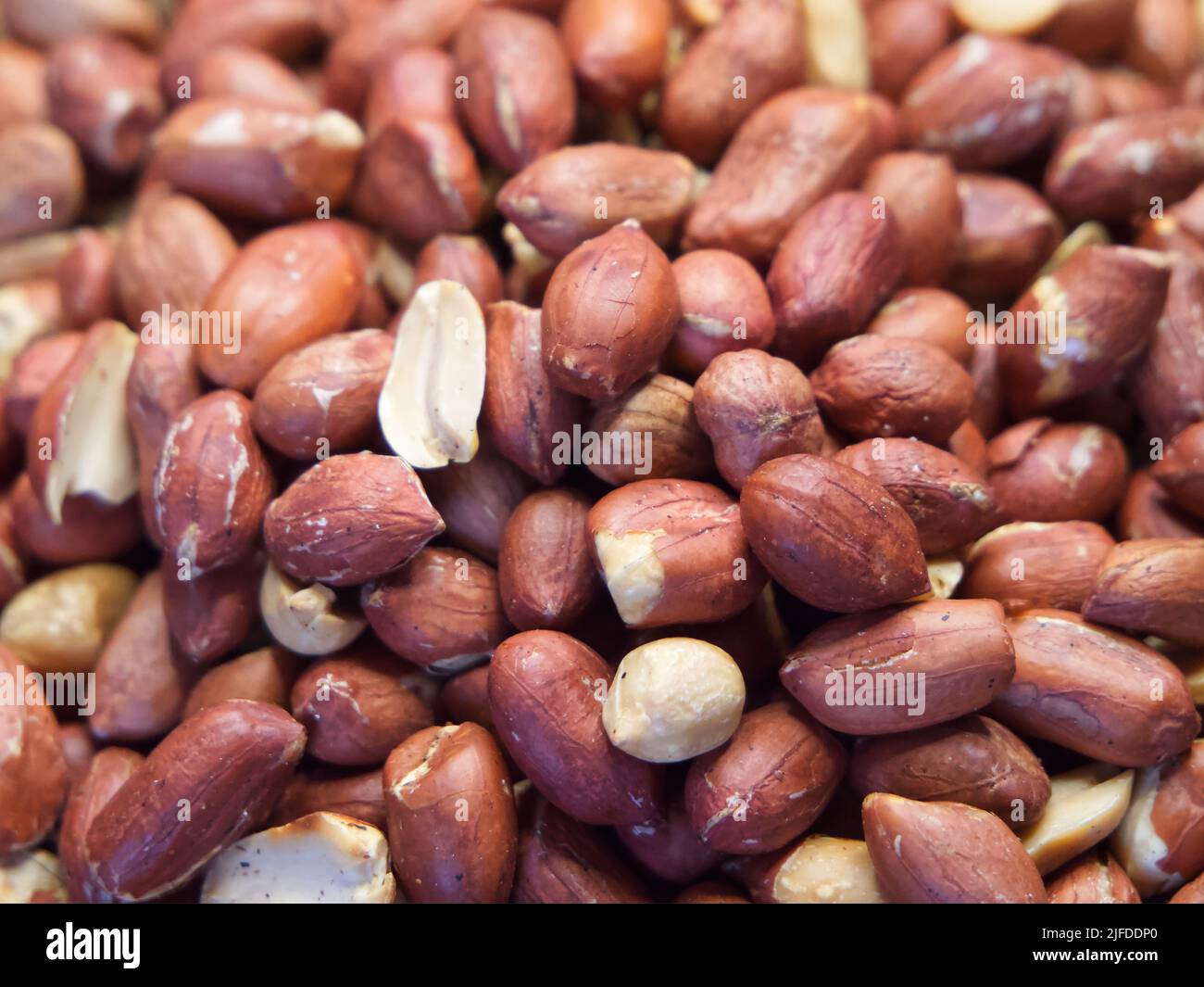 Roasted unpeeled peanuts macro, peanuts as a background. Groundnut ...