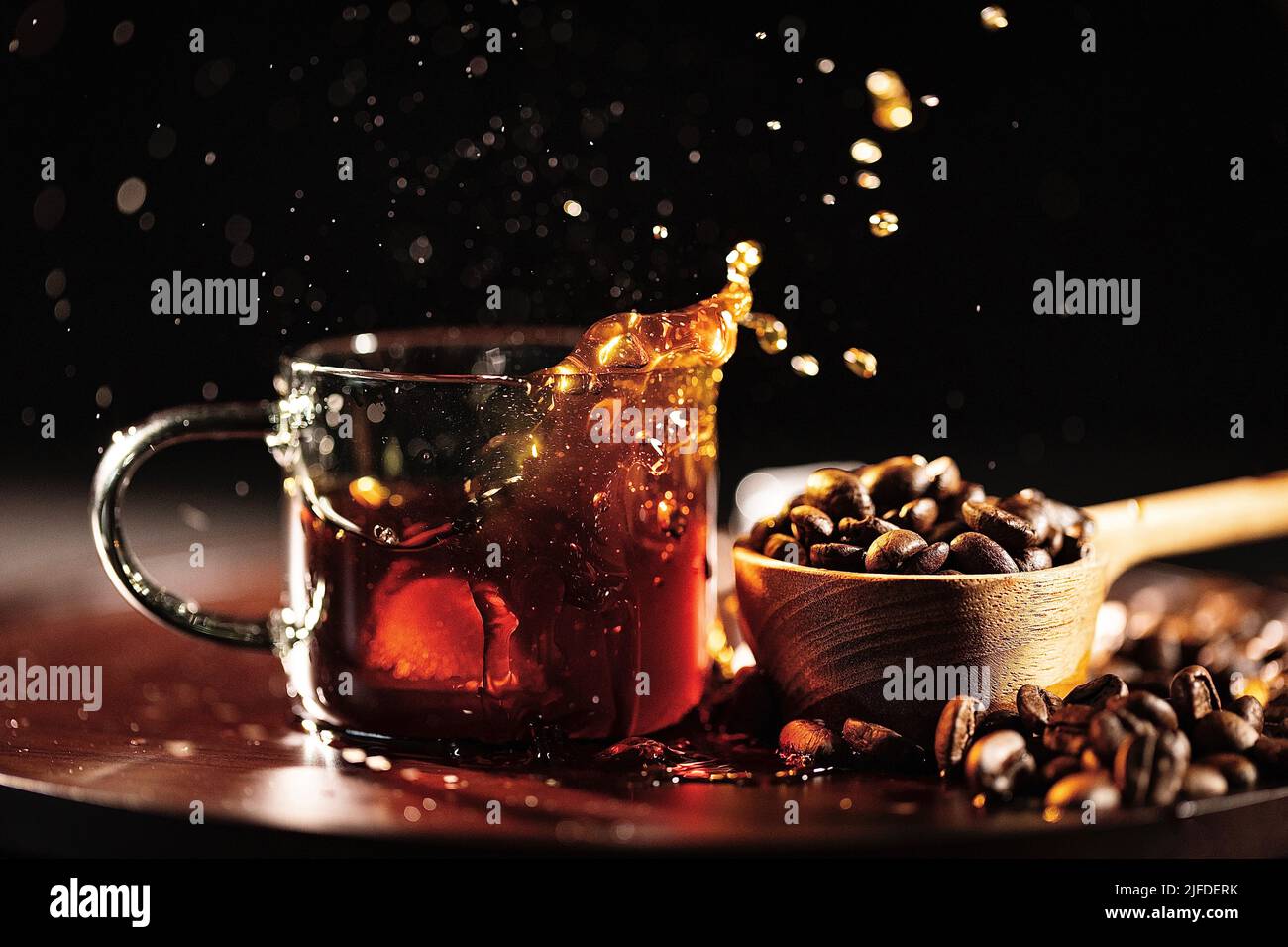 Adding ice cubes to black coffee, the traditional artisanal coffee ...