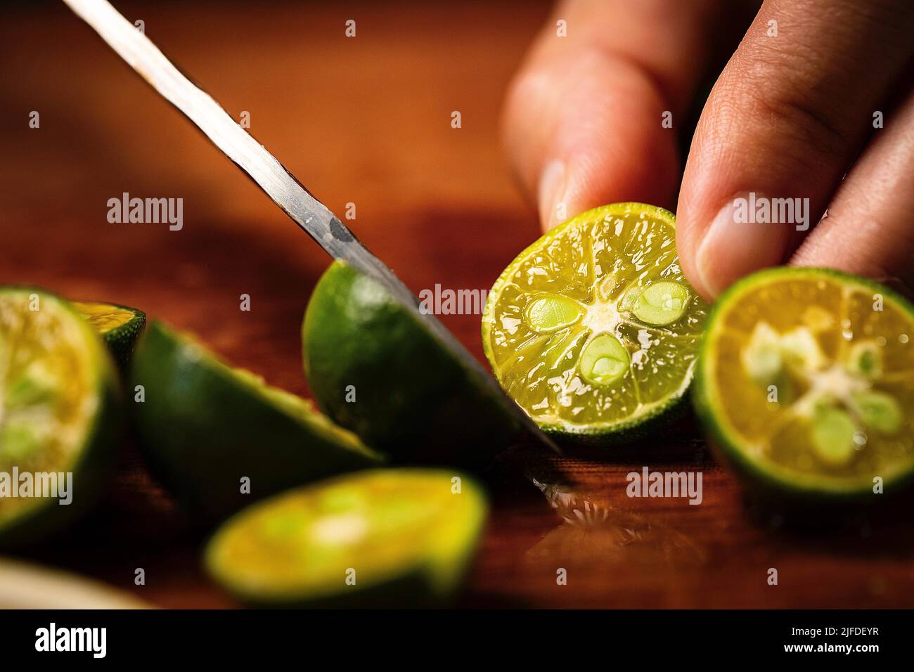 Cutting small lime in half, cool and fruity cold drink making process ...