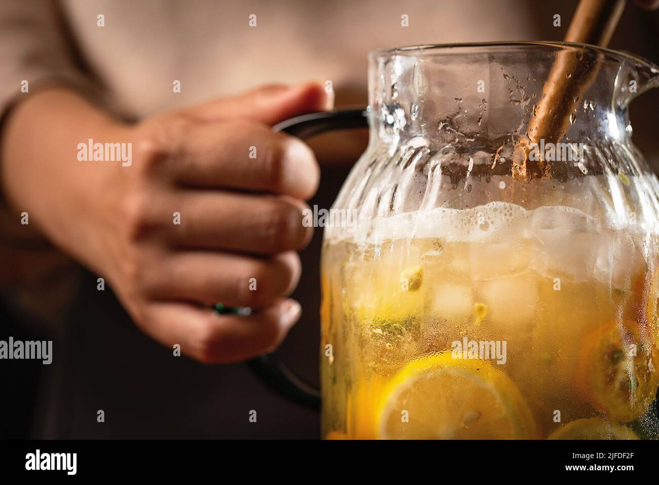 Stirring the chilled citrus fruit mix in a glass jar, cool and fruity ...