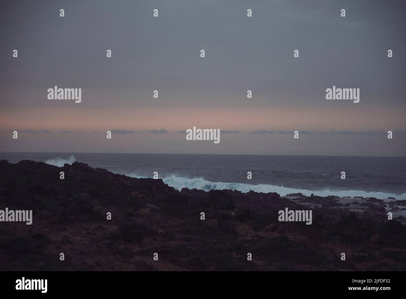 A beautiful view of the Lanzarote beach and gray sunset sky on the ...