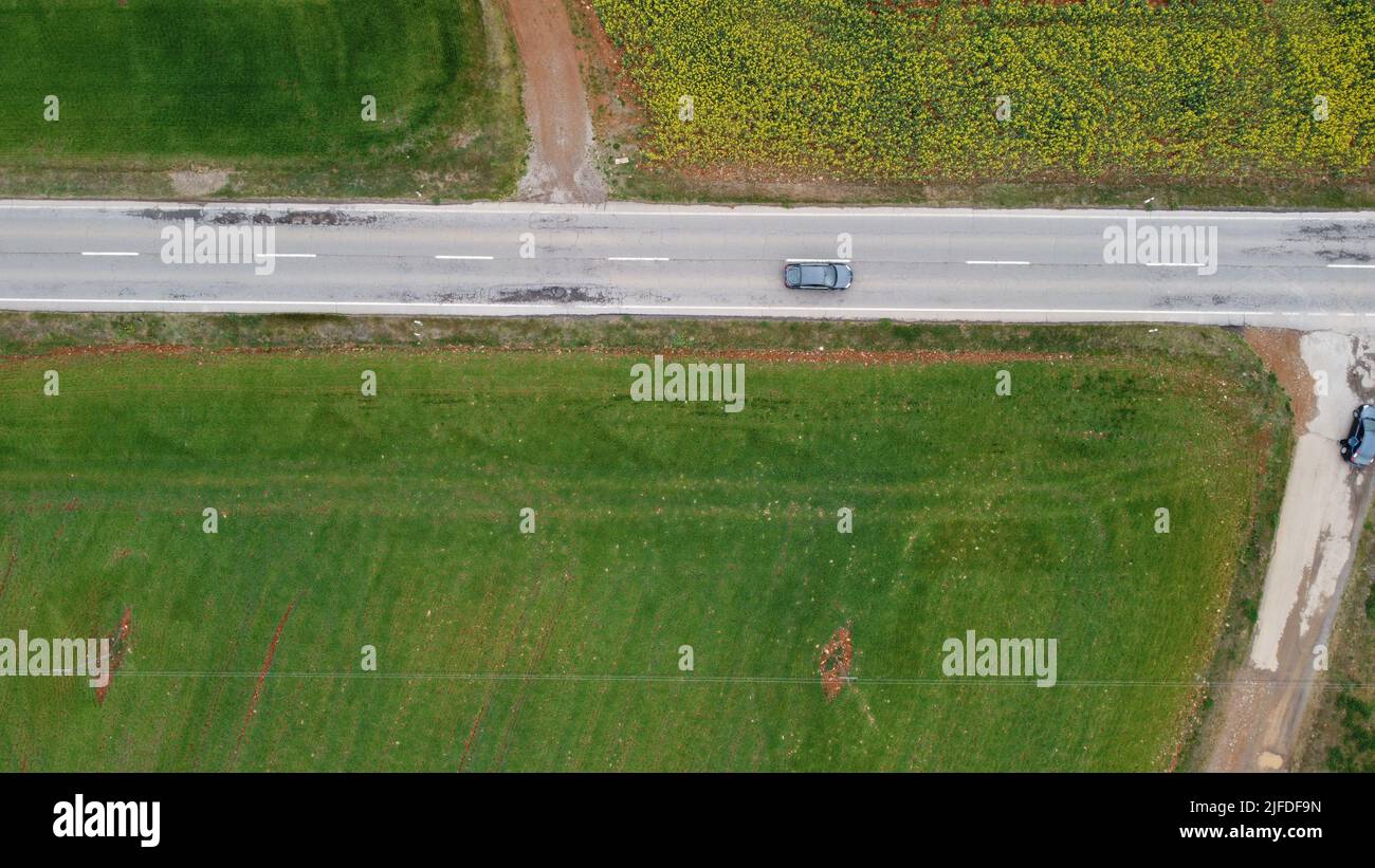 An aerial view of cars driving in through the field Stock Photo - Alamy
