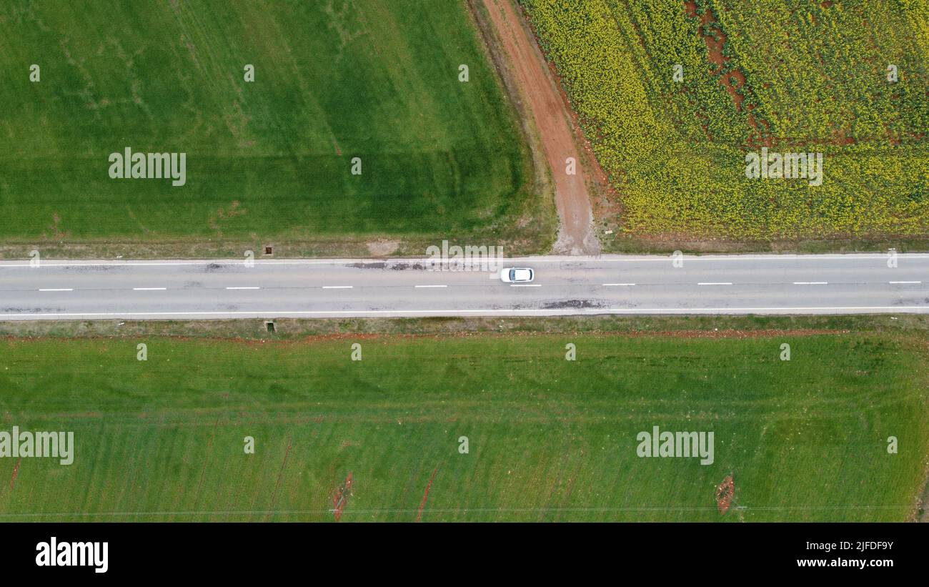 An aerial view of cars driving in through the field Stock Photo - Alamy