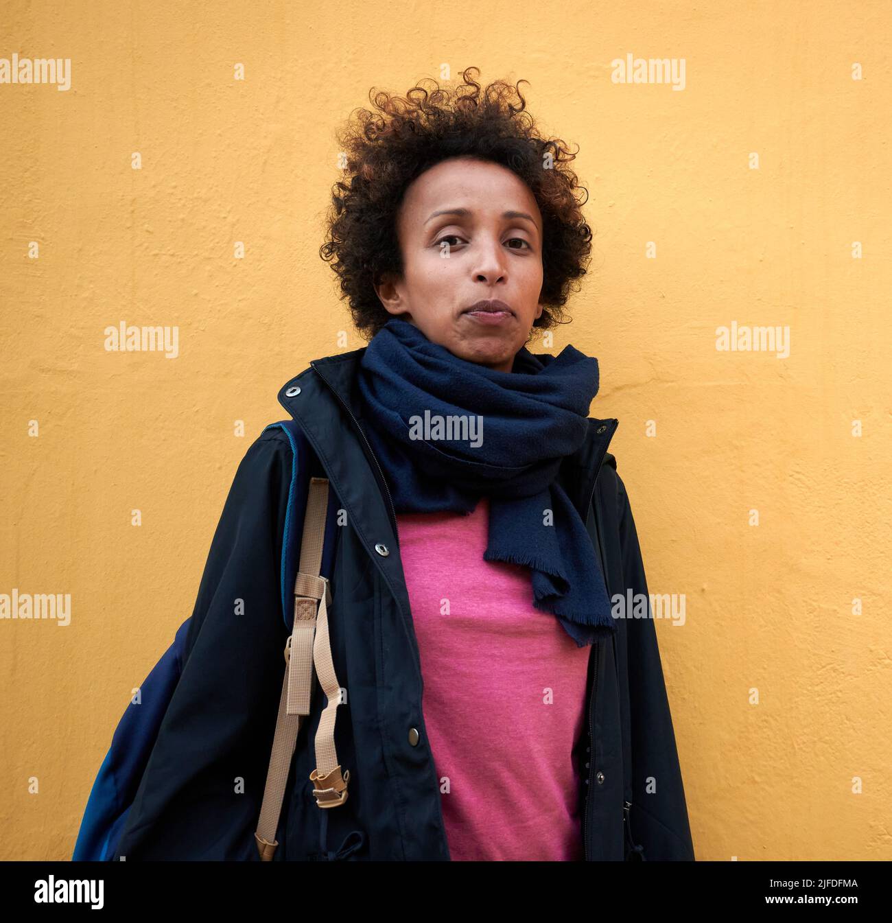 A Beautiful Curly Haired African American Female In Casual Clothes On