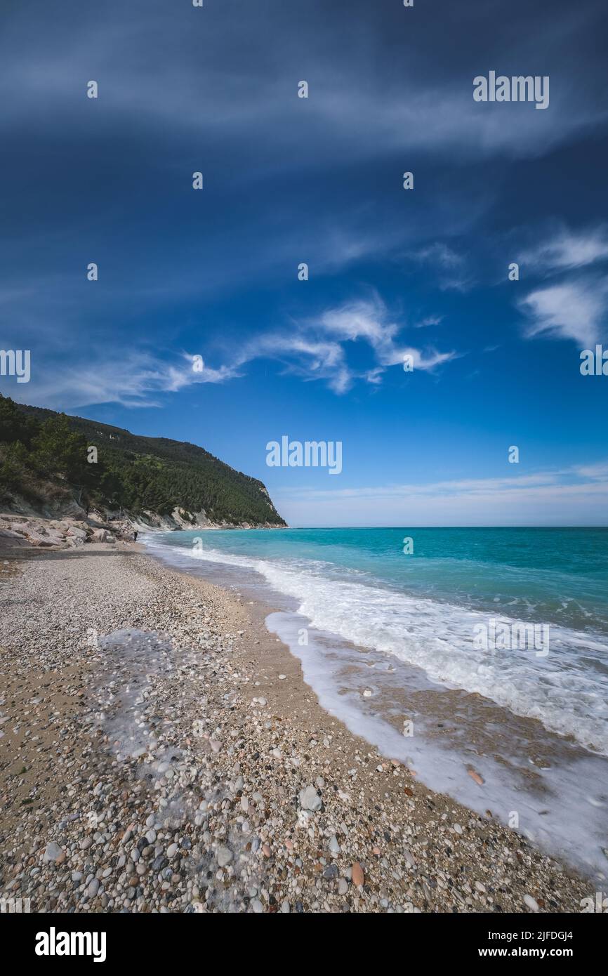 The vertical view of the coastline of a beautiful blue ocean under the ...