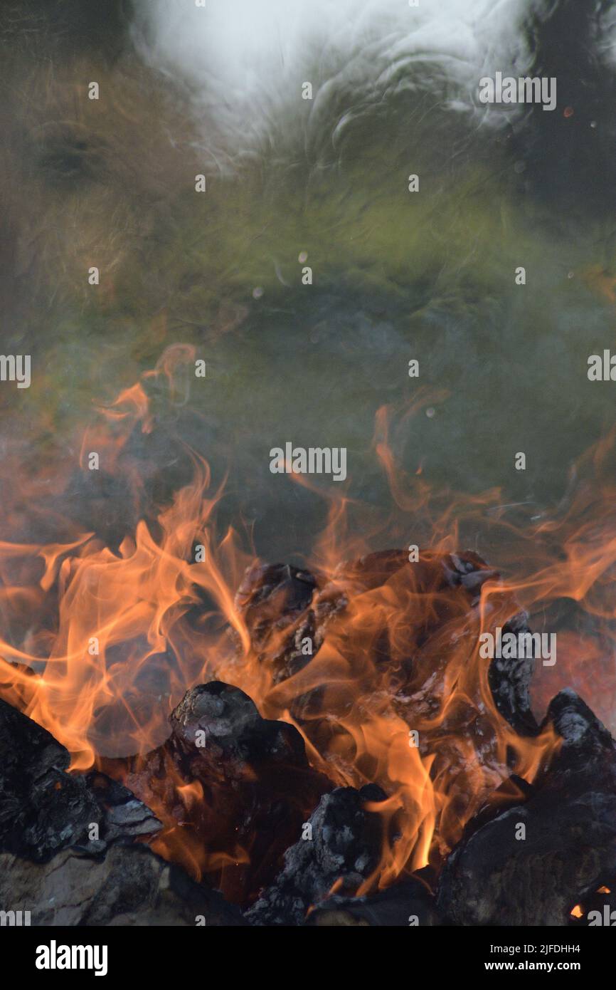 Fire in wooden logs burning of a barbecue Stock Photo - Alamy