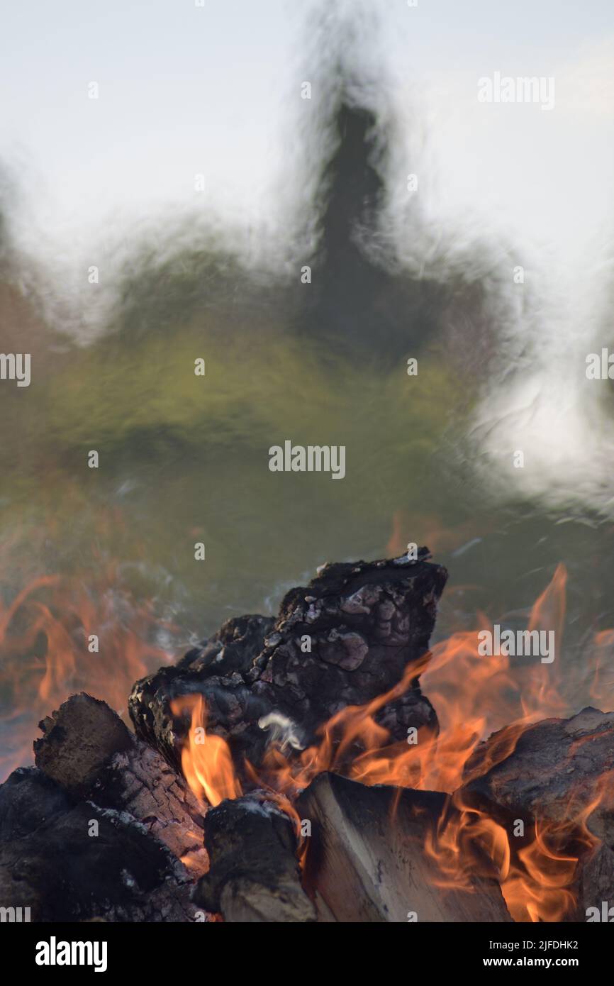 Wooden logs burning in a popular barbecue Stock Photo - Alamy
