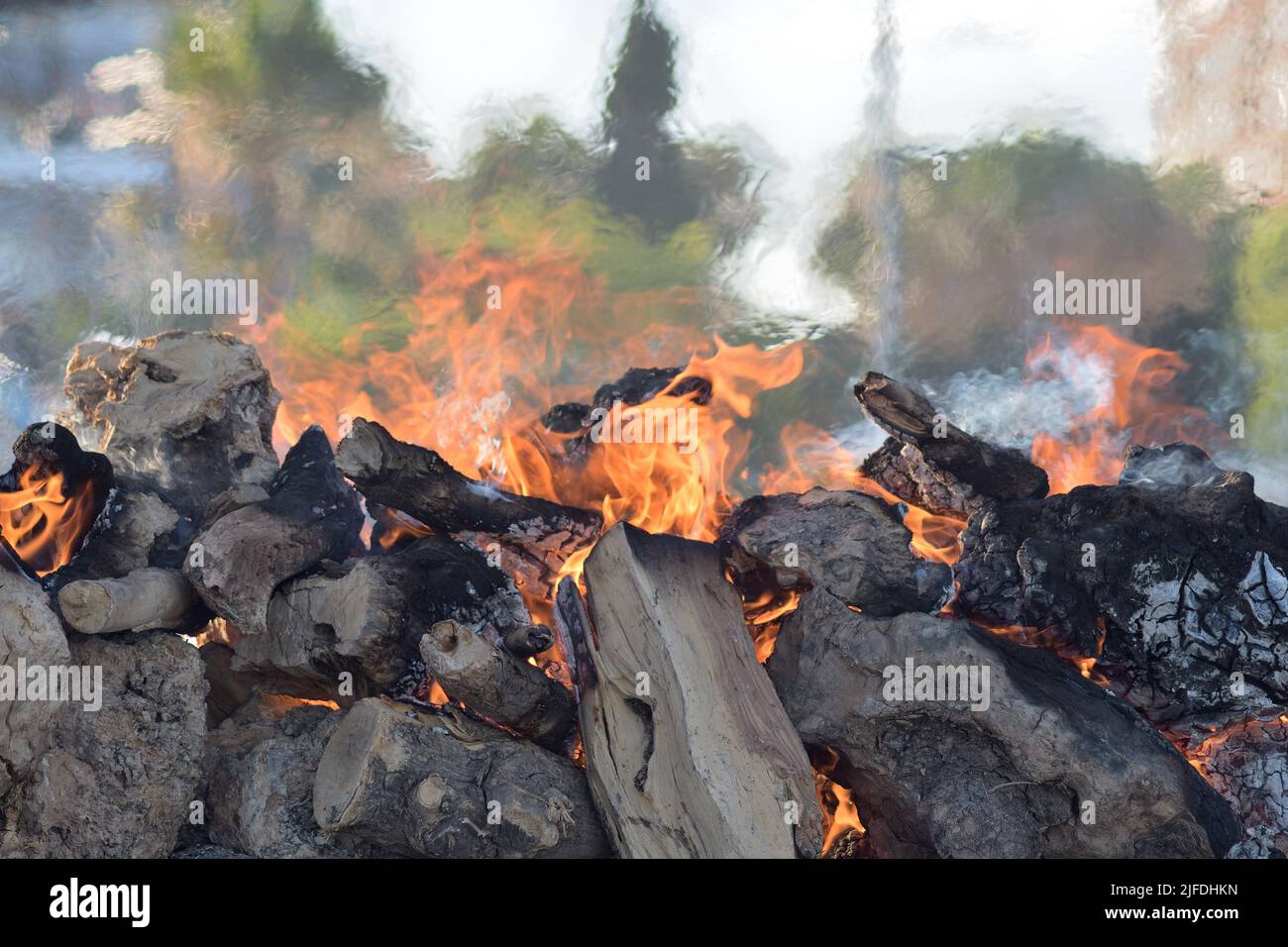 Wooden logs burning in a bonfire outdoor Stock Photo - Alamy