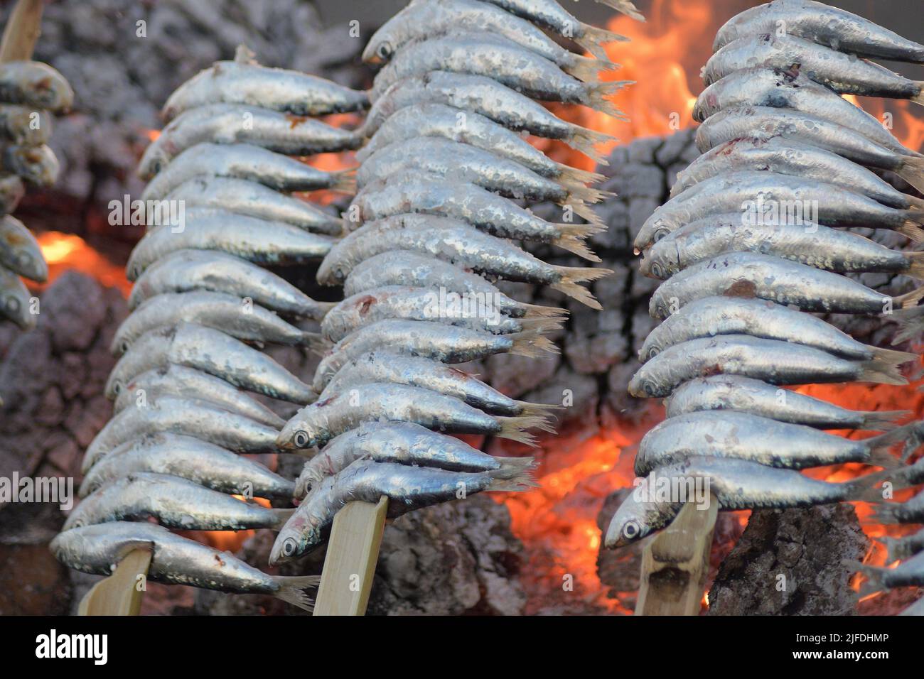 Typical sardines espeto at grill in a popular barbecue Stock Photo - Alamy