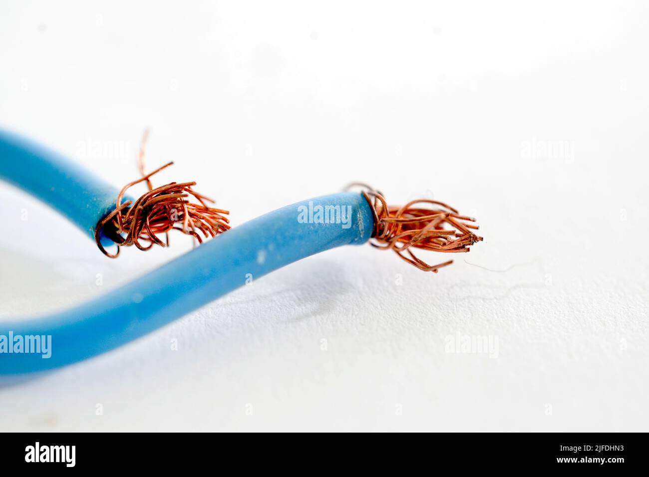 Old twisted copper cable on white Stock Photo - Alamy