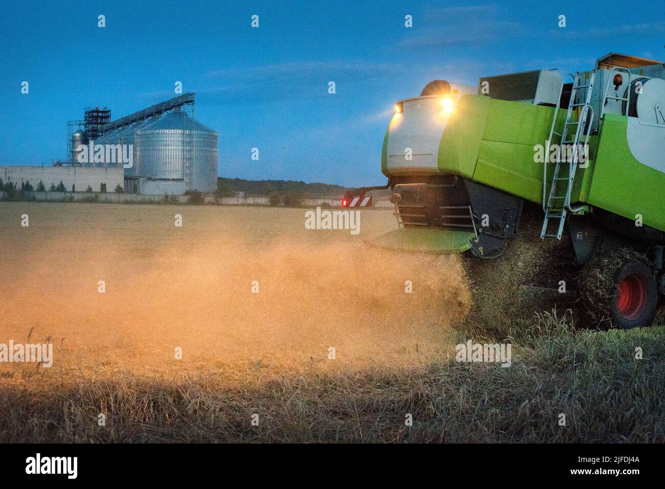 harvest at night, an element of a combine harvester in a wheat field ...