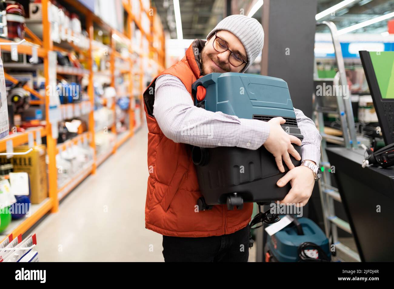 happy customer hugging a construction vacuum cleaner in a construction ...