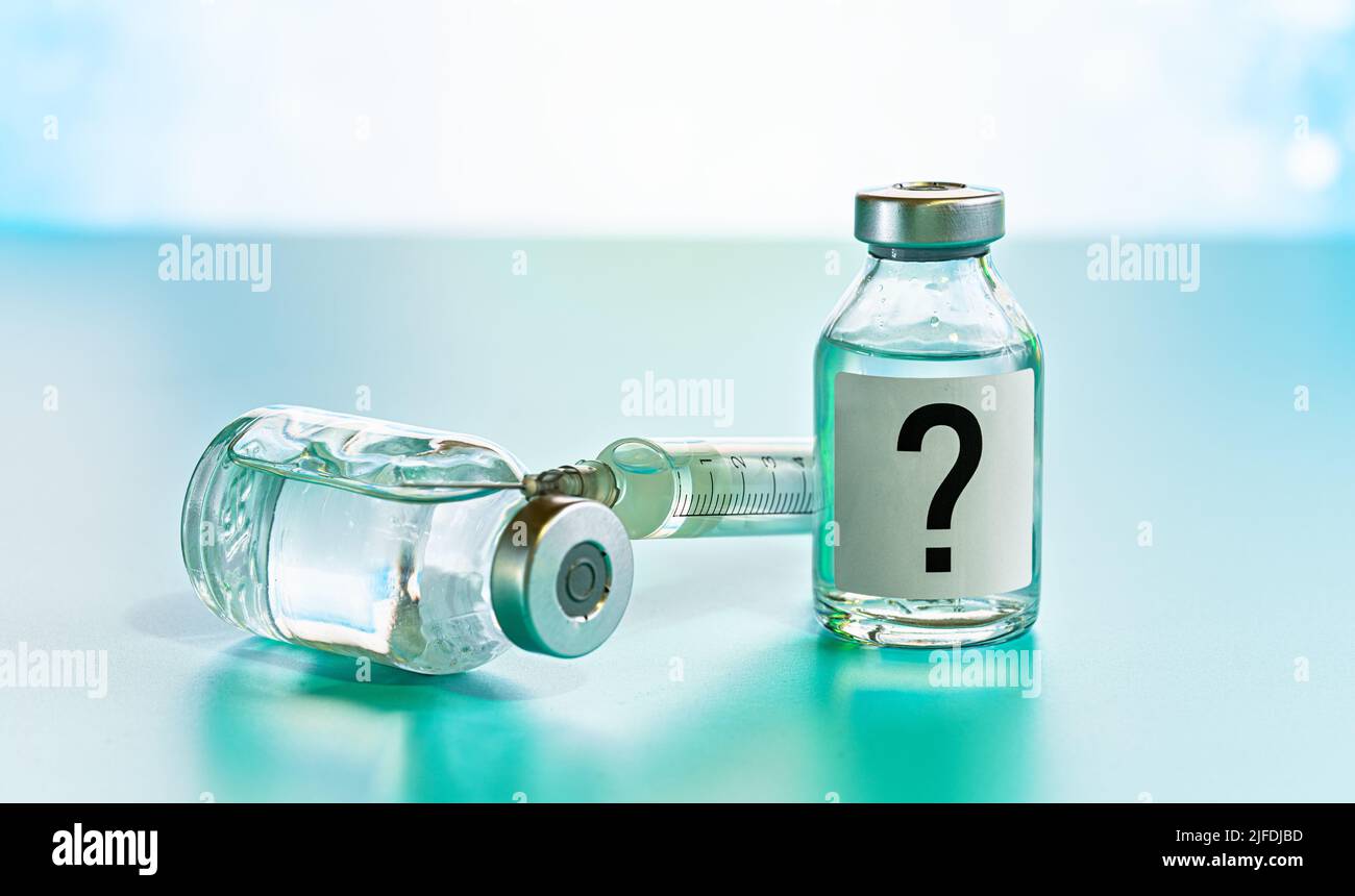 Vaccine bottle with hypodermic syringe needle near, question mark on ...