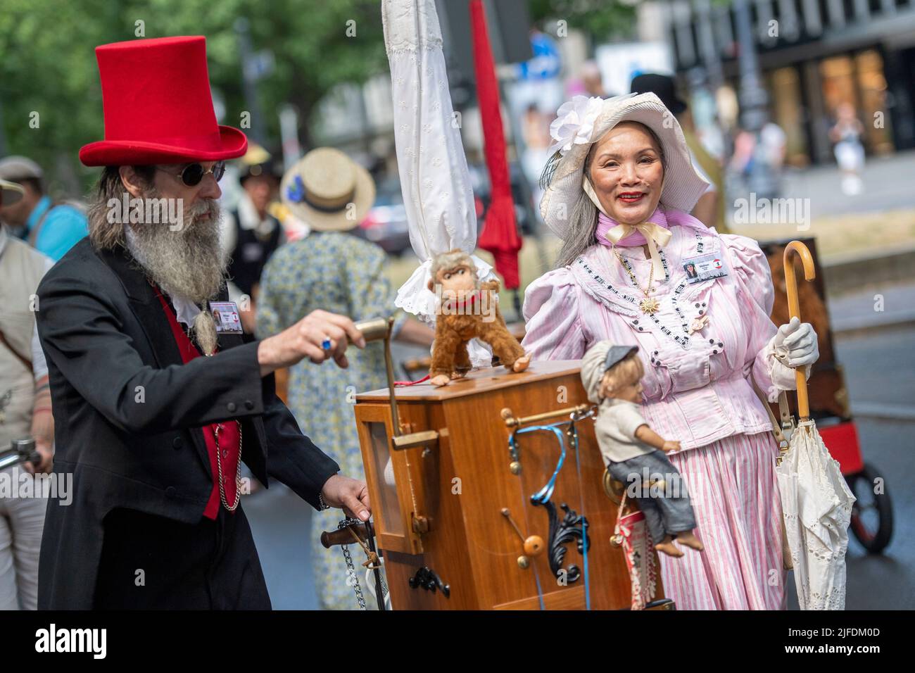 Berlin, Germany. 02nd July, 2022. Barrel organ players walk down ...