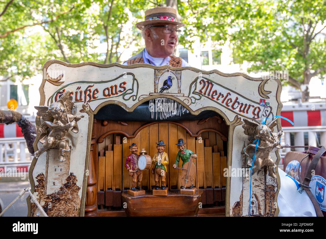 Berlin, Germany. 02nd July, 2022. A barrel organ player walks down ...