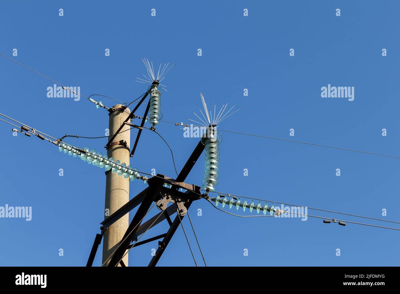 Concrete electricity pylon with glass insulators and bird spikes ...