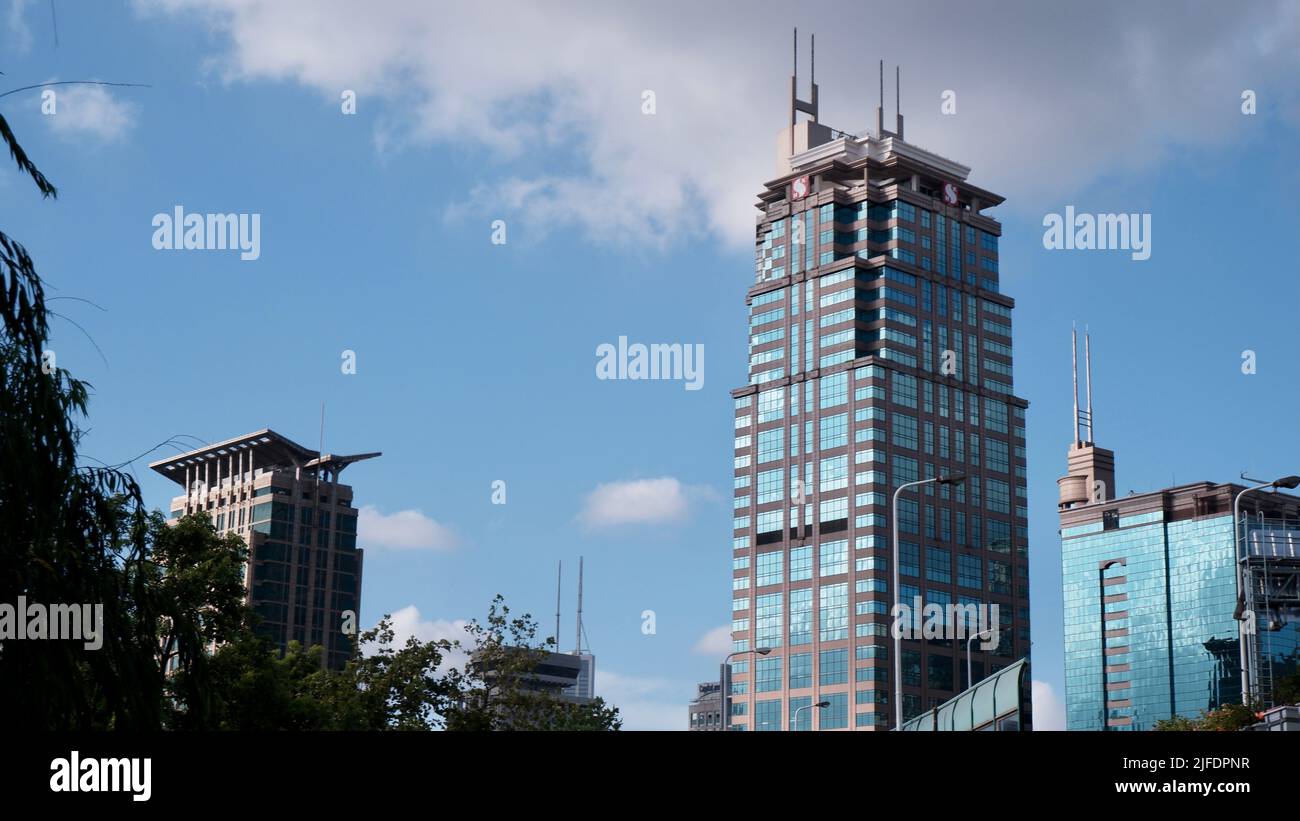 The famous Shanghai Central Plaza in China under a bright cloudy sky ...