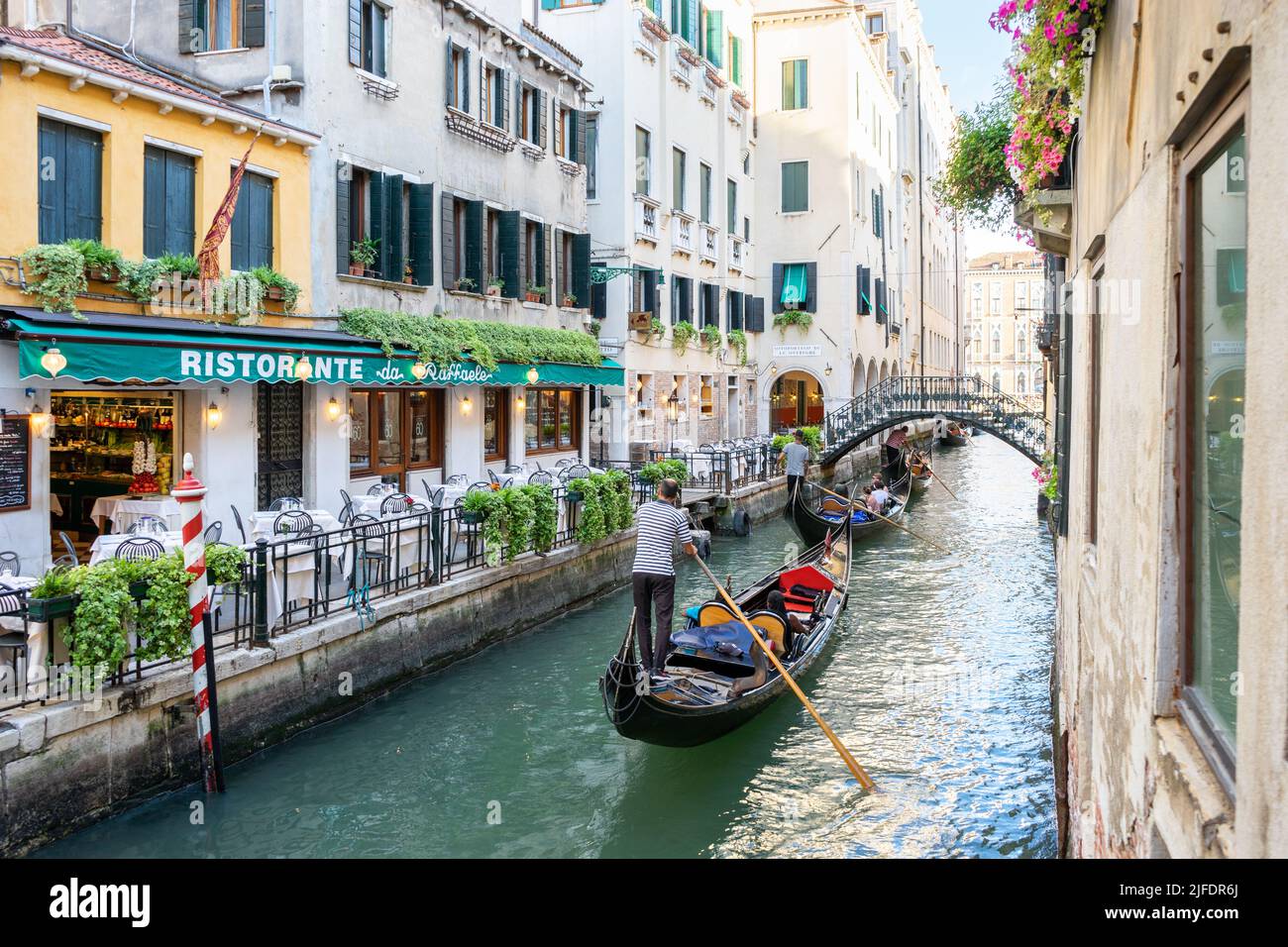A group of people on a Gondola cruising on the Canal in Venice, Italy ...