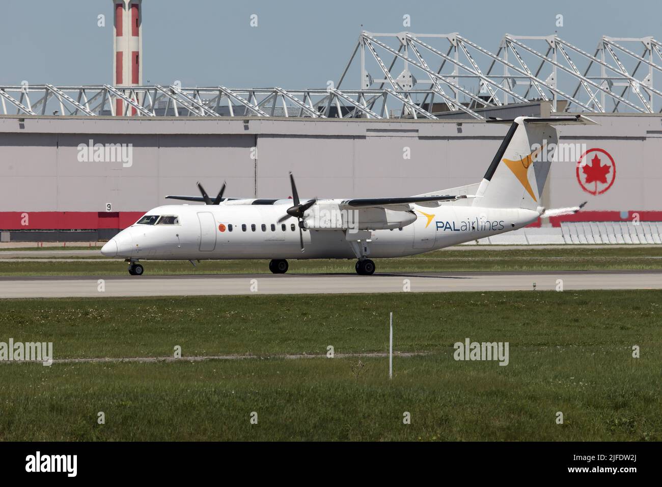 A PAL Airlines Bombardier Dash 8--300 taking off from Montreal Pierre ...