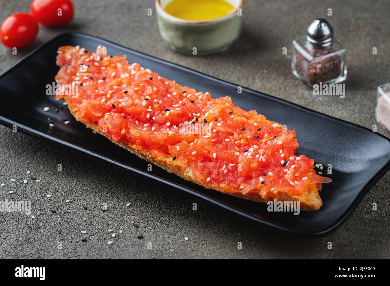 Traditional Spanish breakfast. Tostada with different toppings on a ...