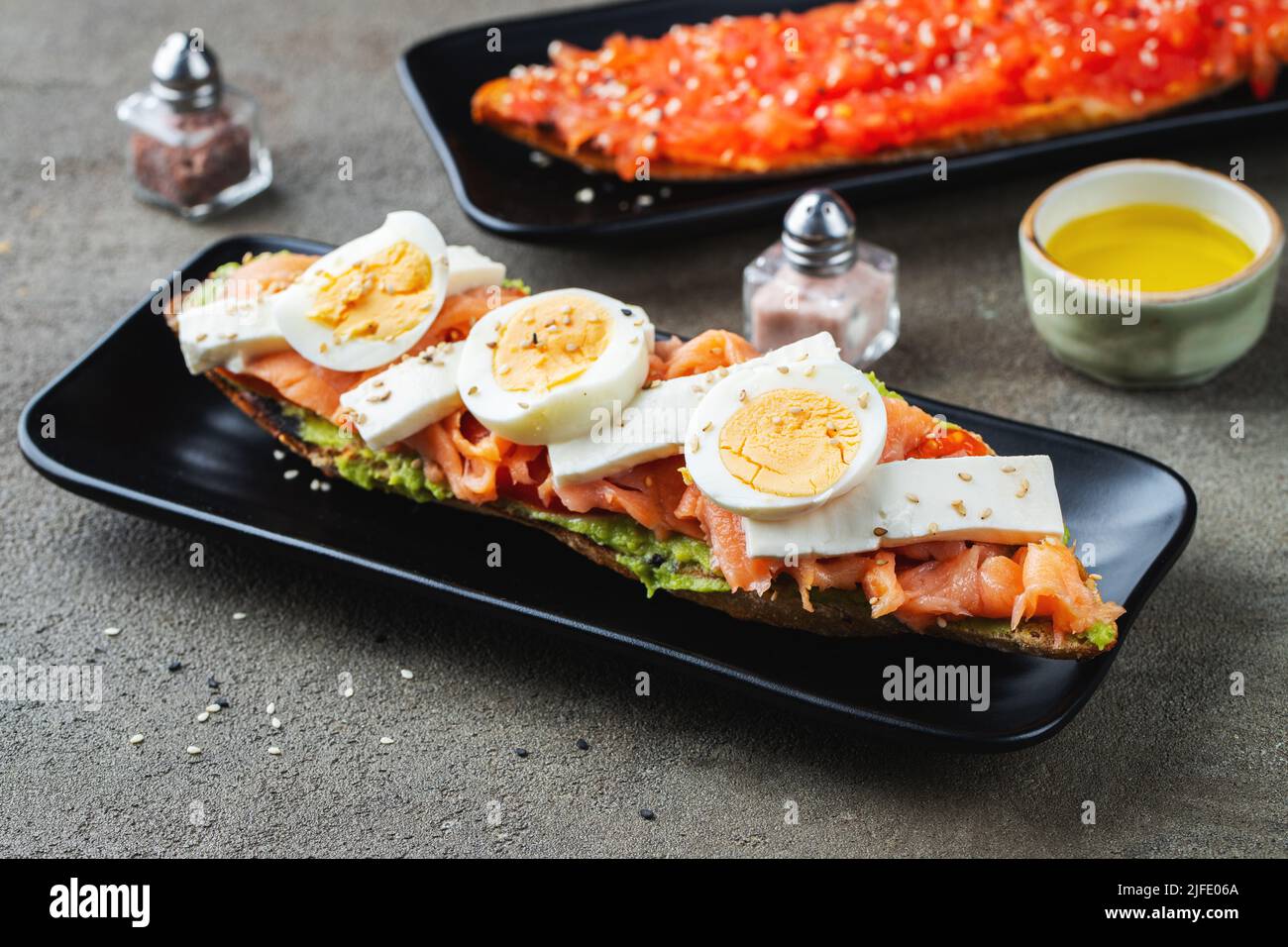 Traditional Spanish breakfast. Tostada with different toppings on a ...