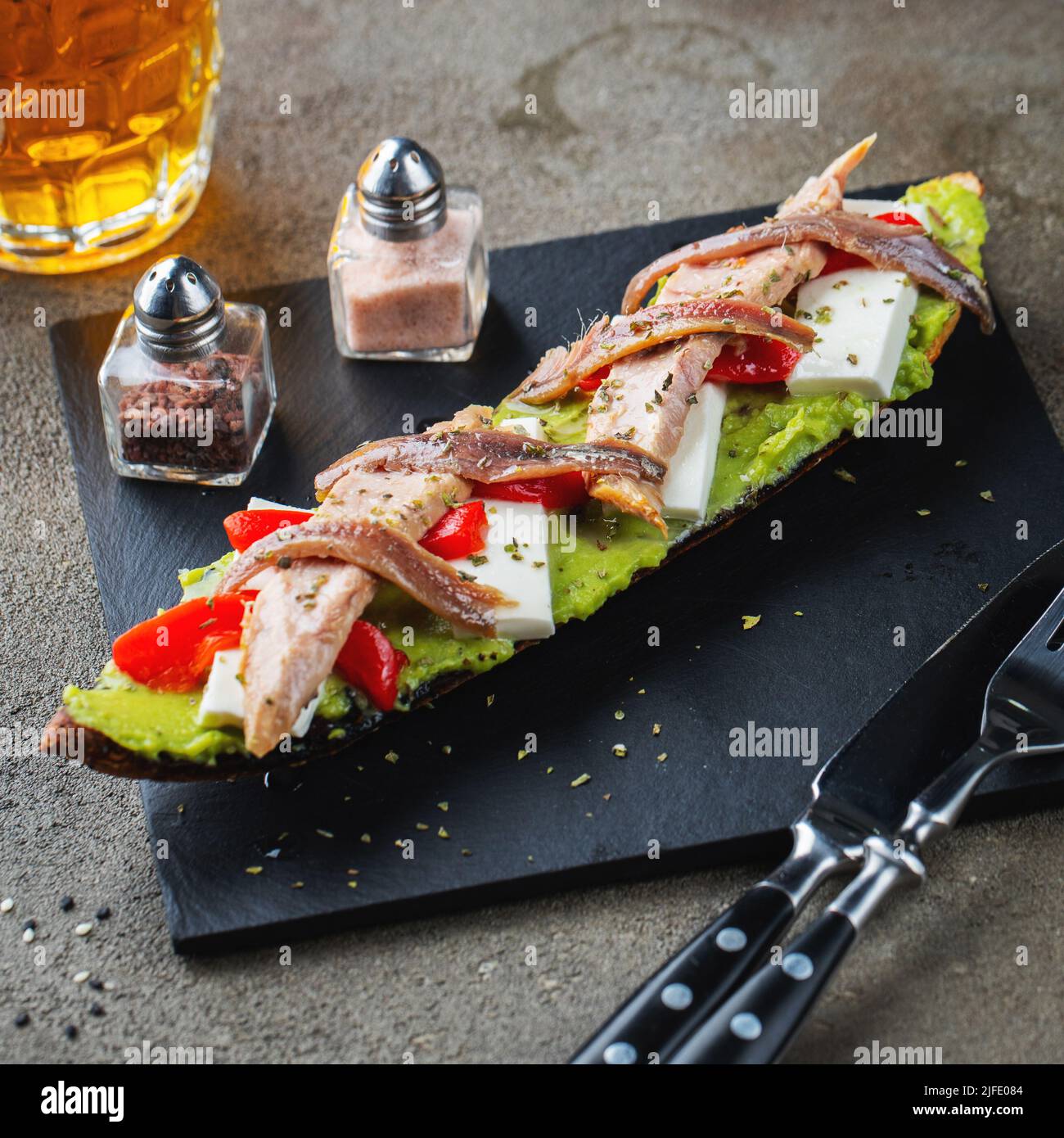 Traditional Spanish breakfast. Tostada with different toppings on a ...