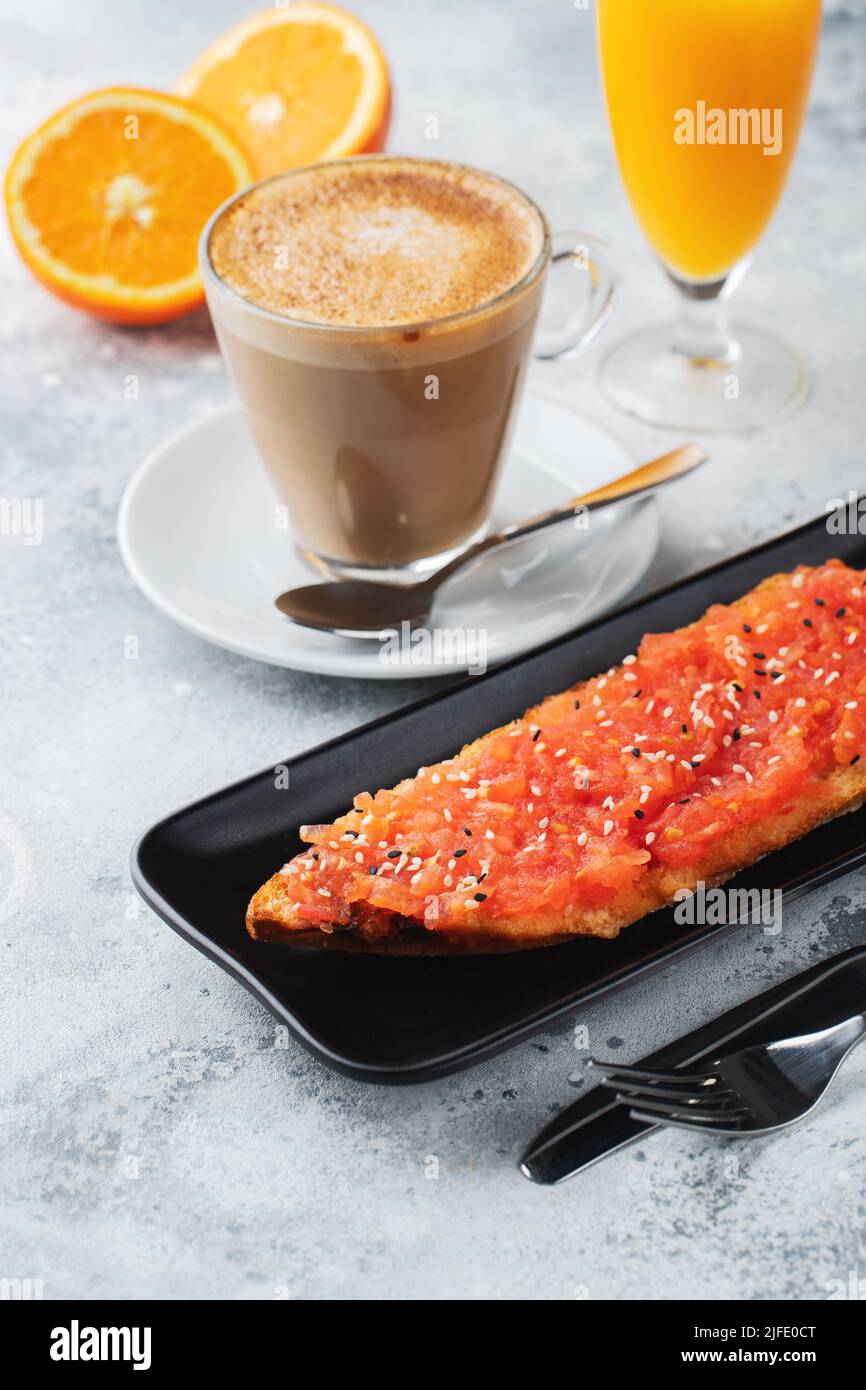 Traditional Spanish breakfast. Tostada with different toppings on a ...