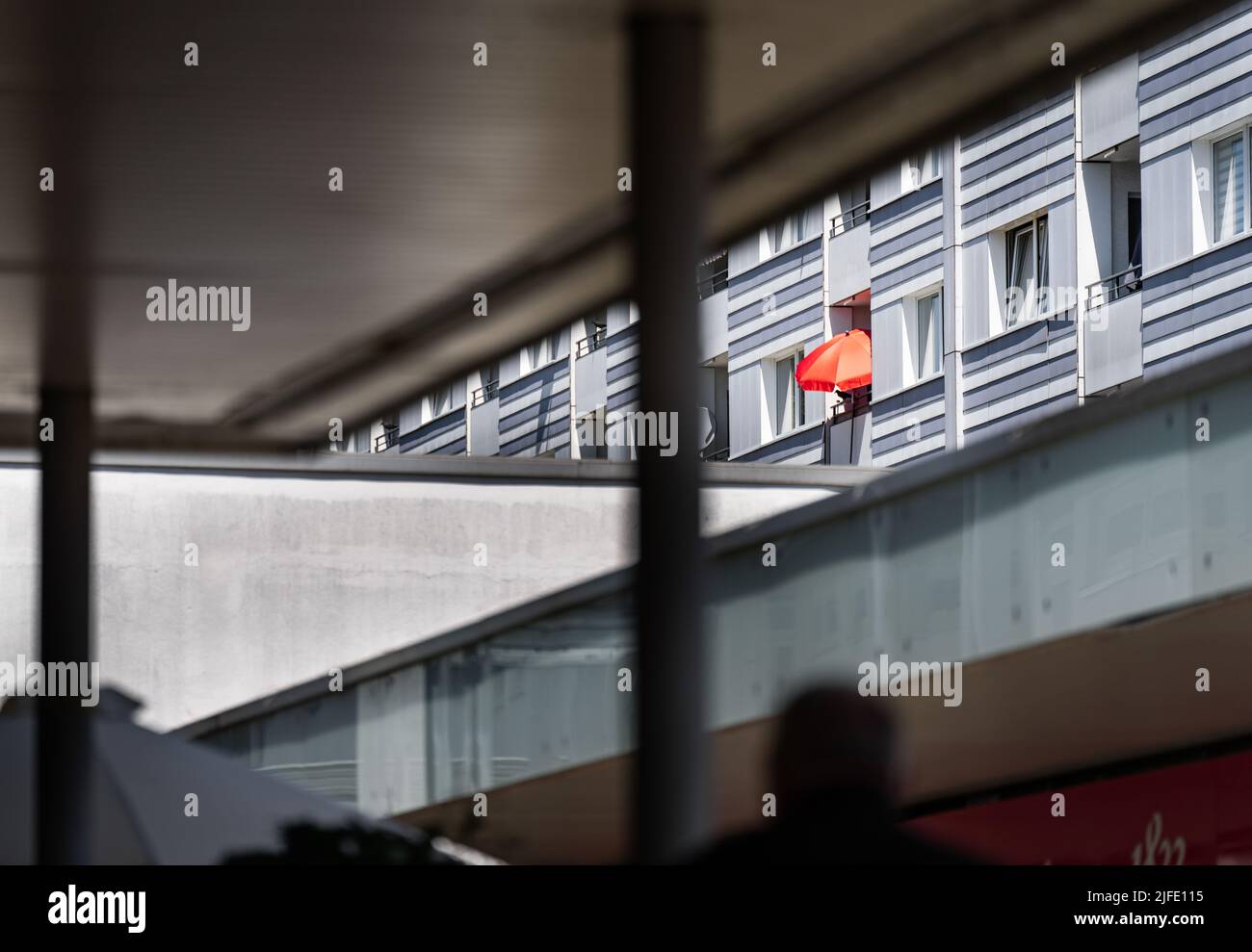 Schwalbach Am Taunus, Germany. 02nd July, 2022. A red parasol peeks out ...