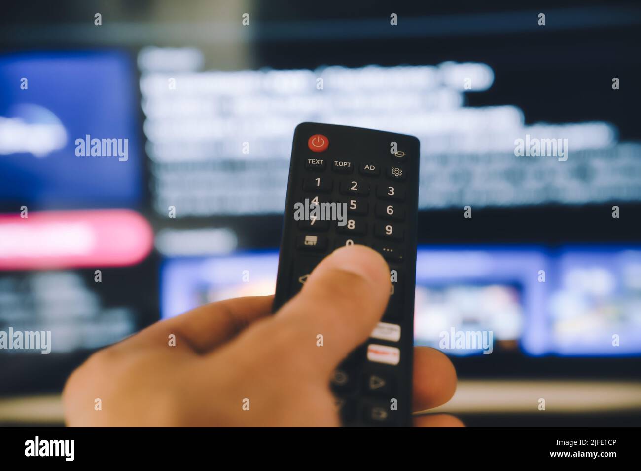 Hand holding tv remote hi-res stock photography and images - Alamy