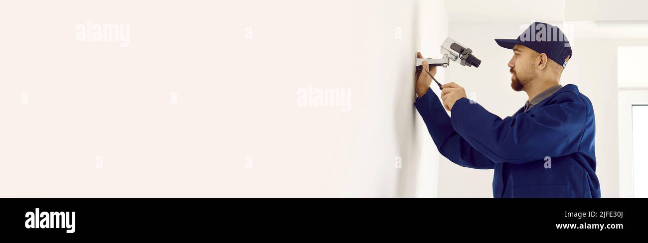 Portrait of busy technician at work. Young man installing or repairing ...