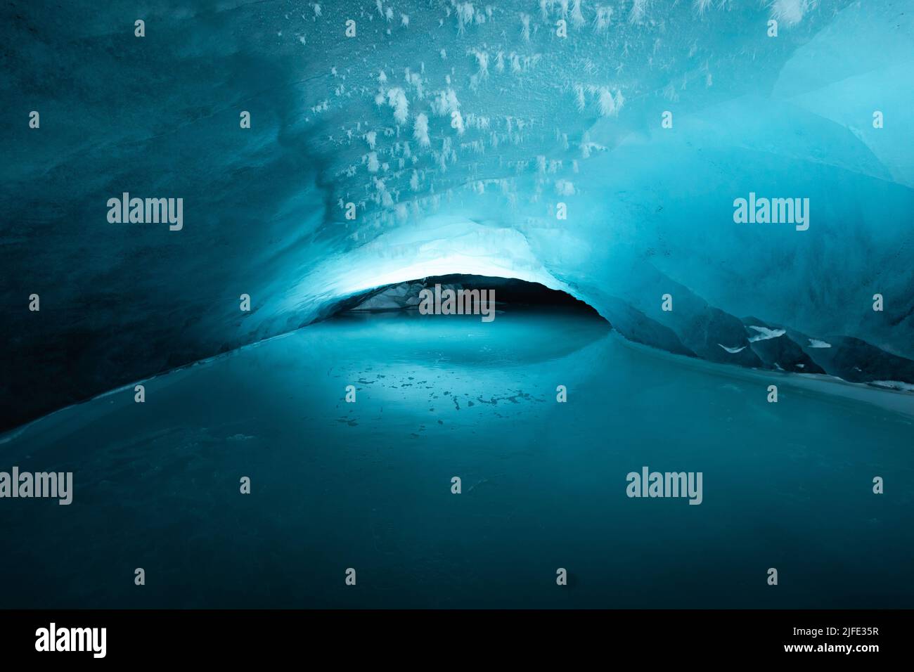 A chilling view of a frozen cave with bright light on the wall Stock ...