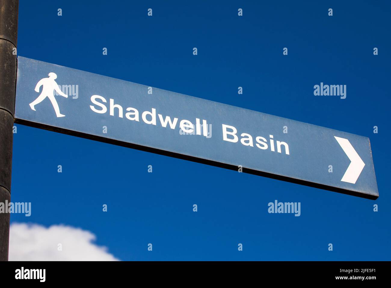 A pedestrian signpost pointing in the direction of Shadwell Basin in ...