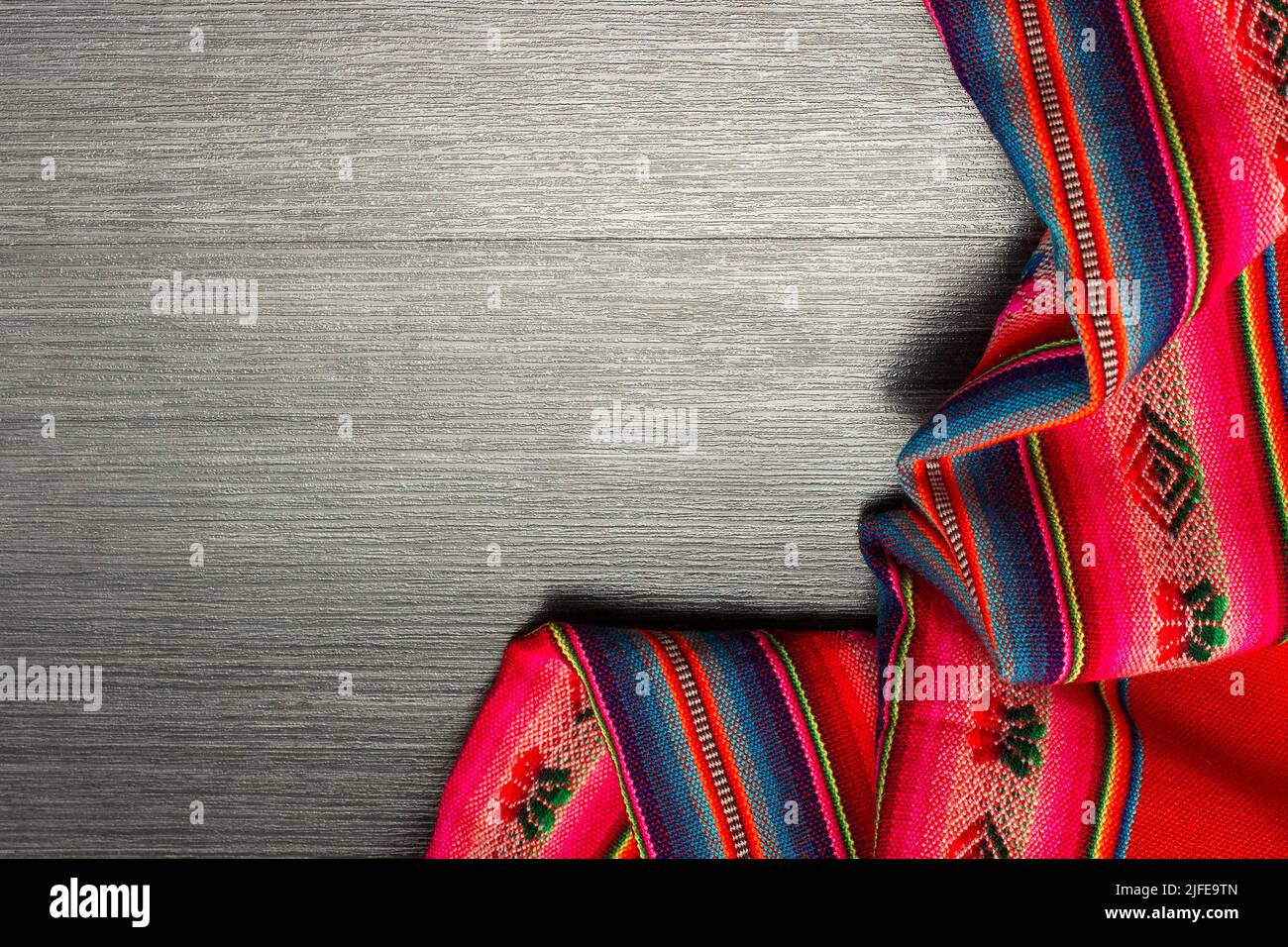 Red pattern tablecloth on wooden table for background. Fabric texture ...
