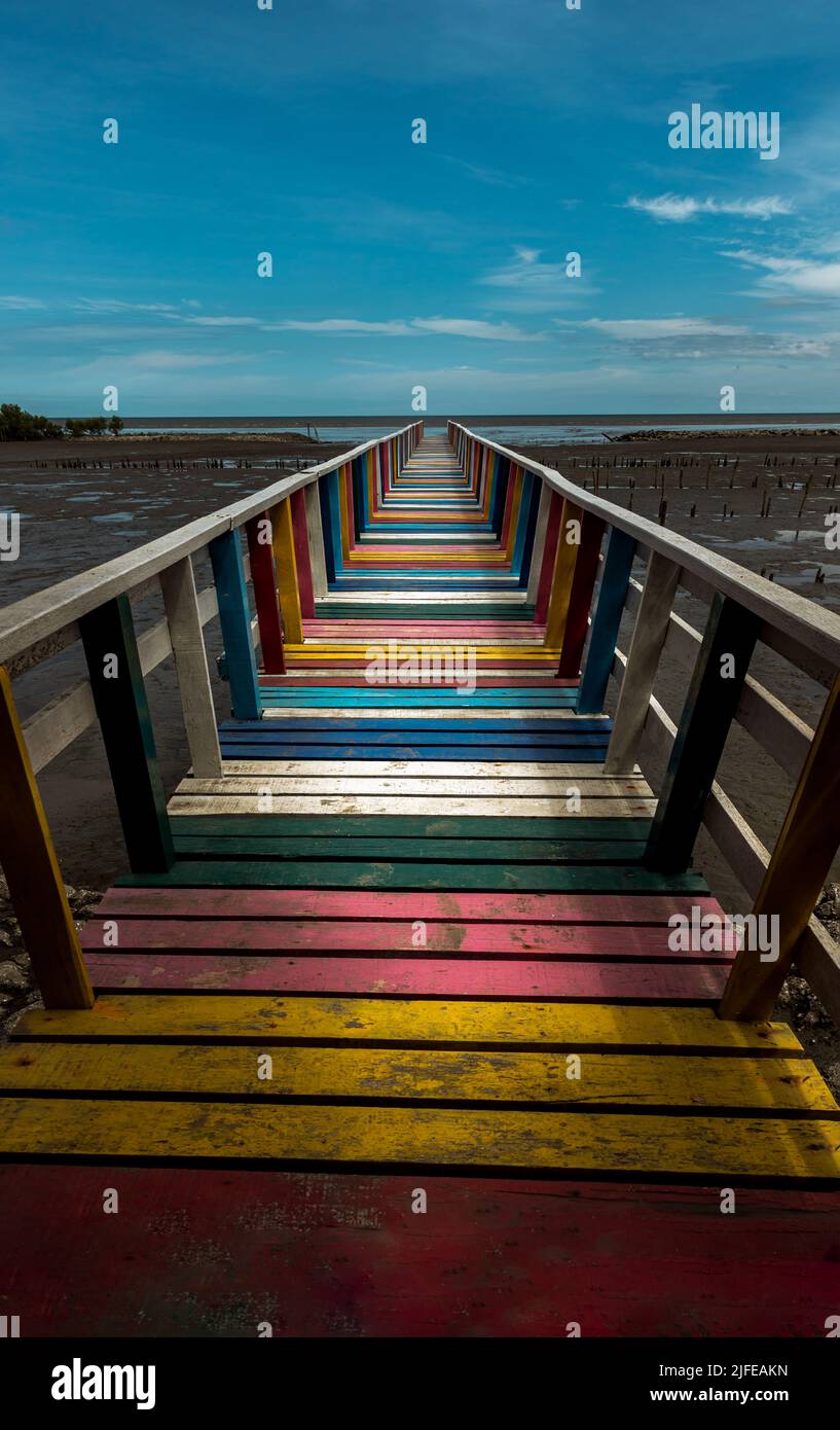 The walkway on Rainbow bridge or Old wood colorful bridge pier extends ...