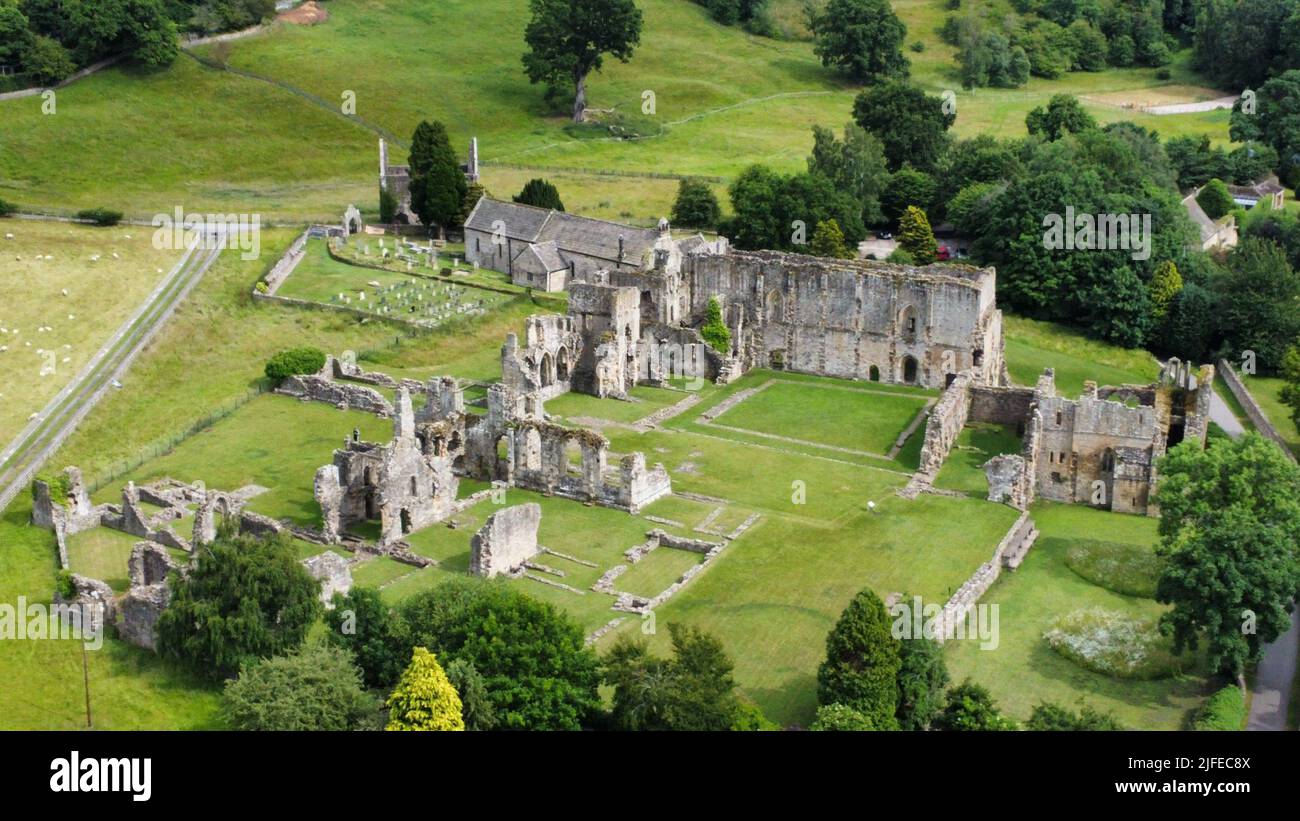 An aerial view of old ruins in a rural area surrounded by green nature ...