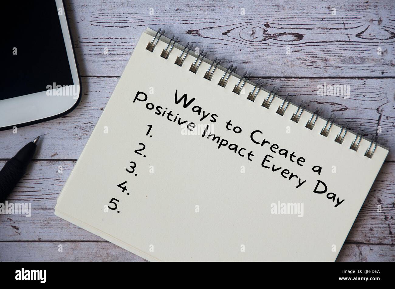 Top view of text - Ways to create a positive impact every day. With ...