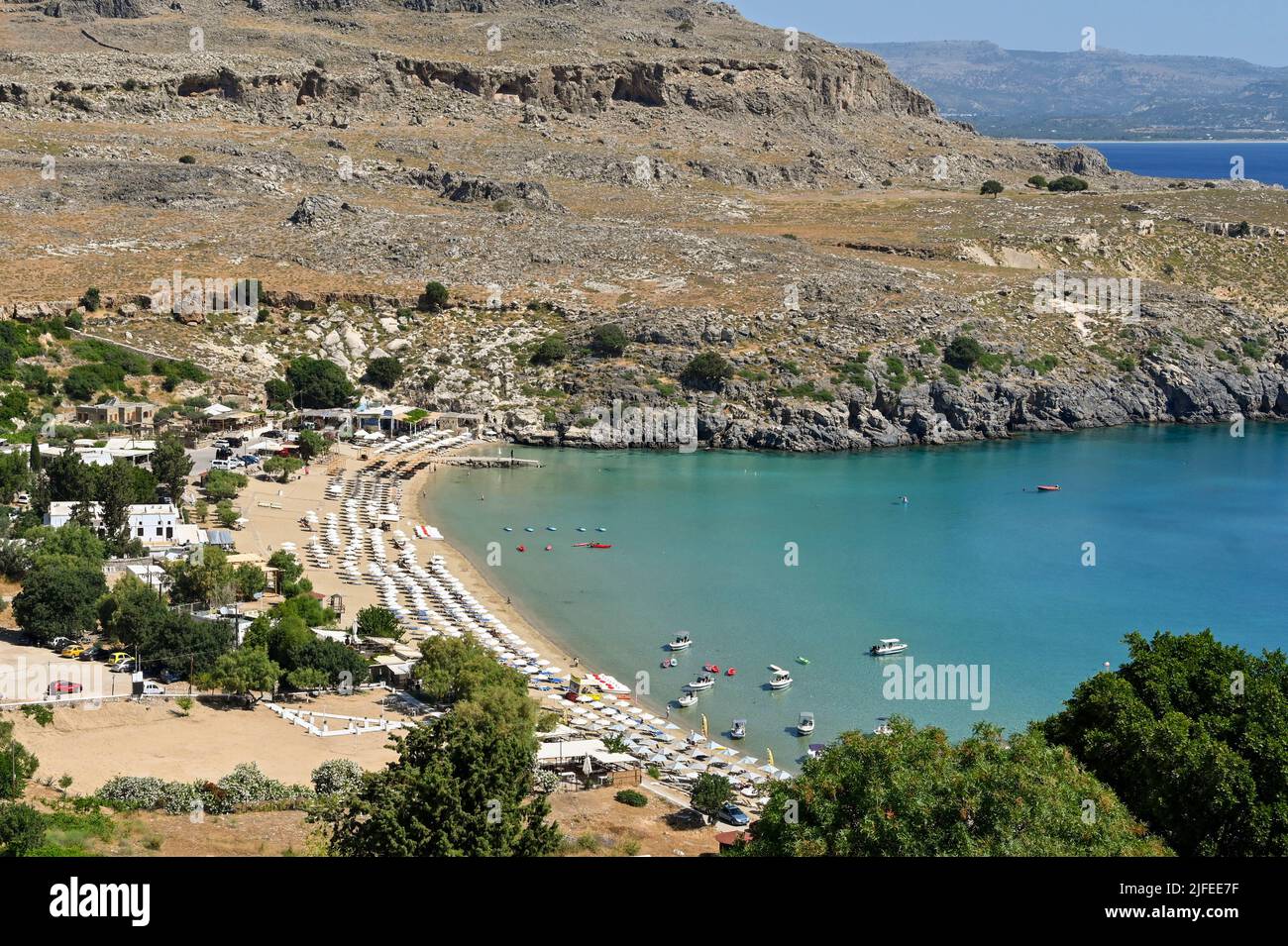 Lindos, Rhodes, Greece - May 2022: Aerial view of the beach with rows ...
