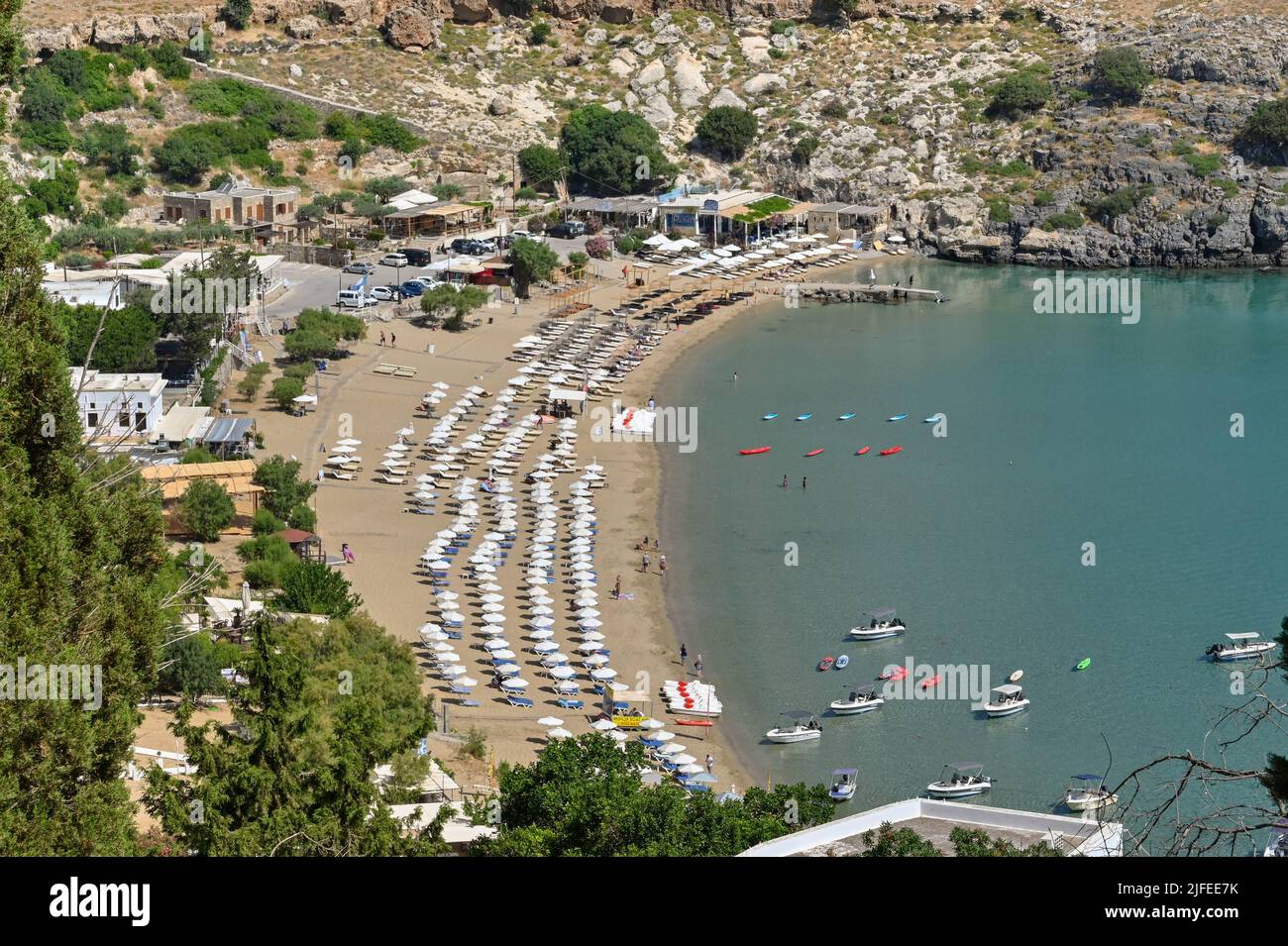 Lindos, Rhodes, Greece - May 2022: Aerial view of the beach with rows ...