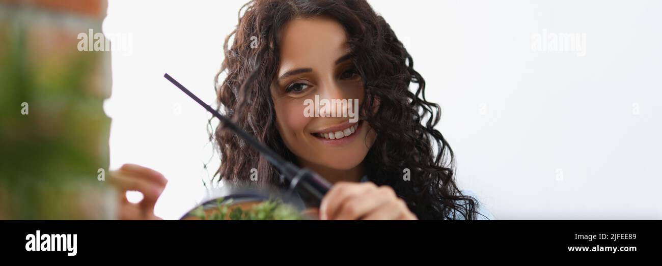 Creating pretty wavy hair with tool Stock Photo - Alamy Creating pretty wavy hair with tool Stock Photo - Alamy