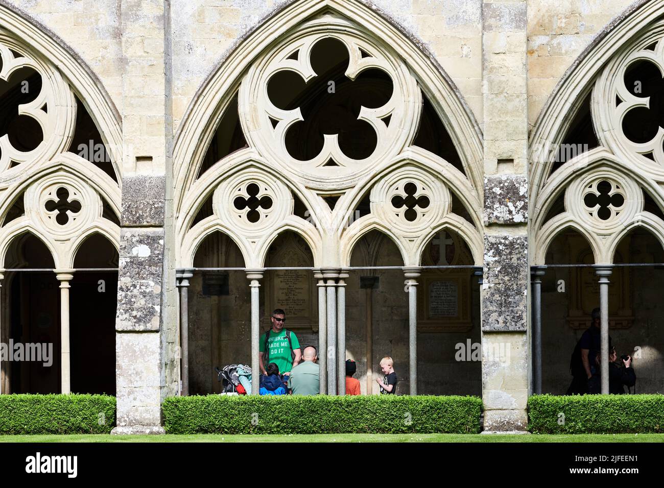 Visitors in the cloister at the medieval christian cathedral of ...