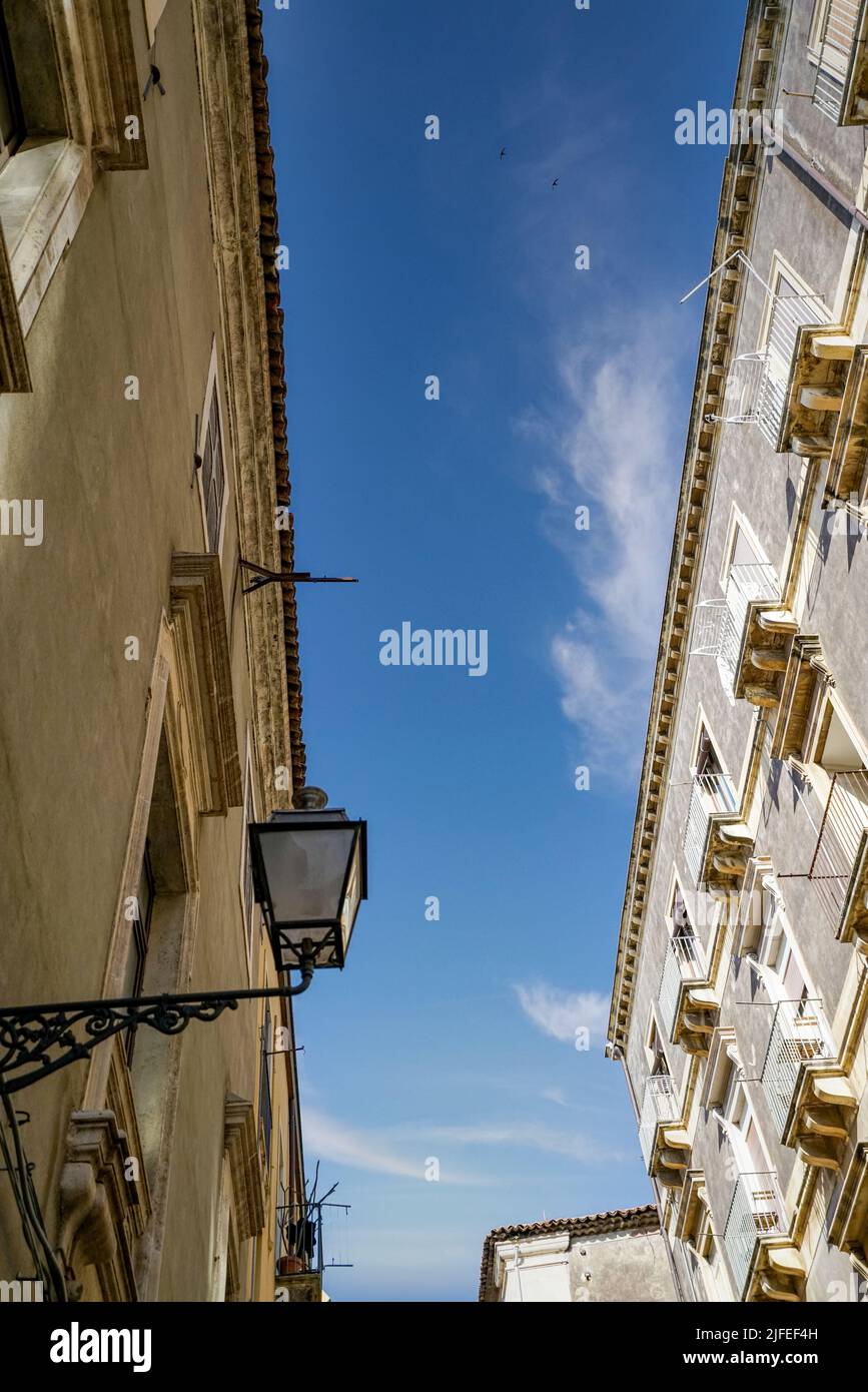 A vertical low angle shot of buildings with balconies Stock Photo - Alamy