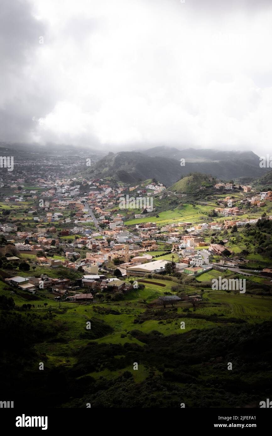A beautiful landscape of a town on a green hill on a cloudy morning ...