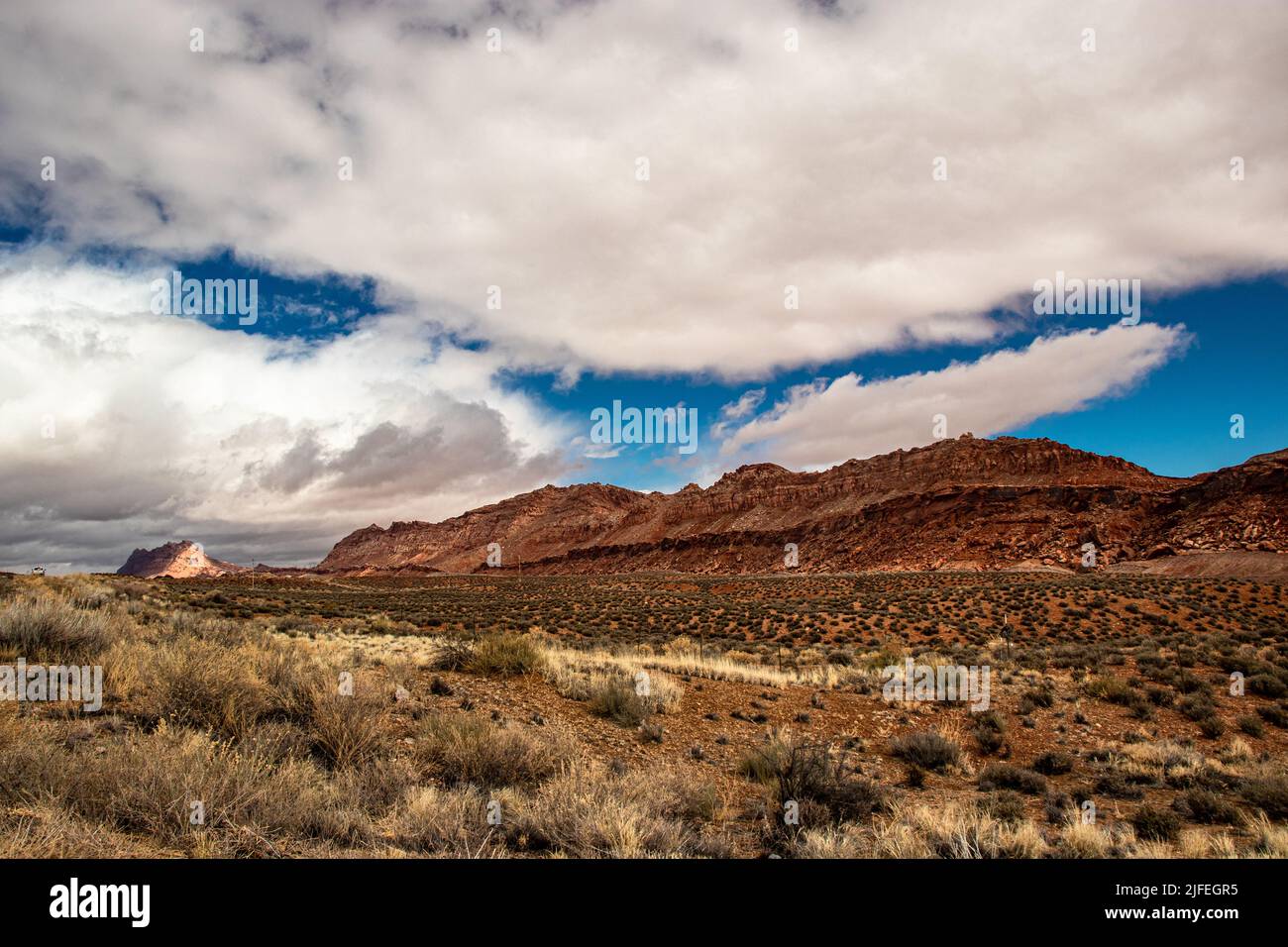 Rugged land and thick white clouds, AZ, USA Stock Photo - Alamy