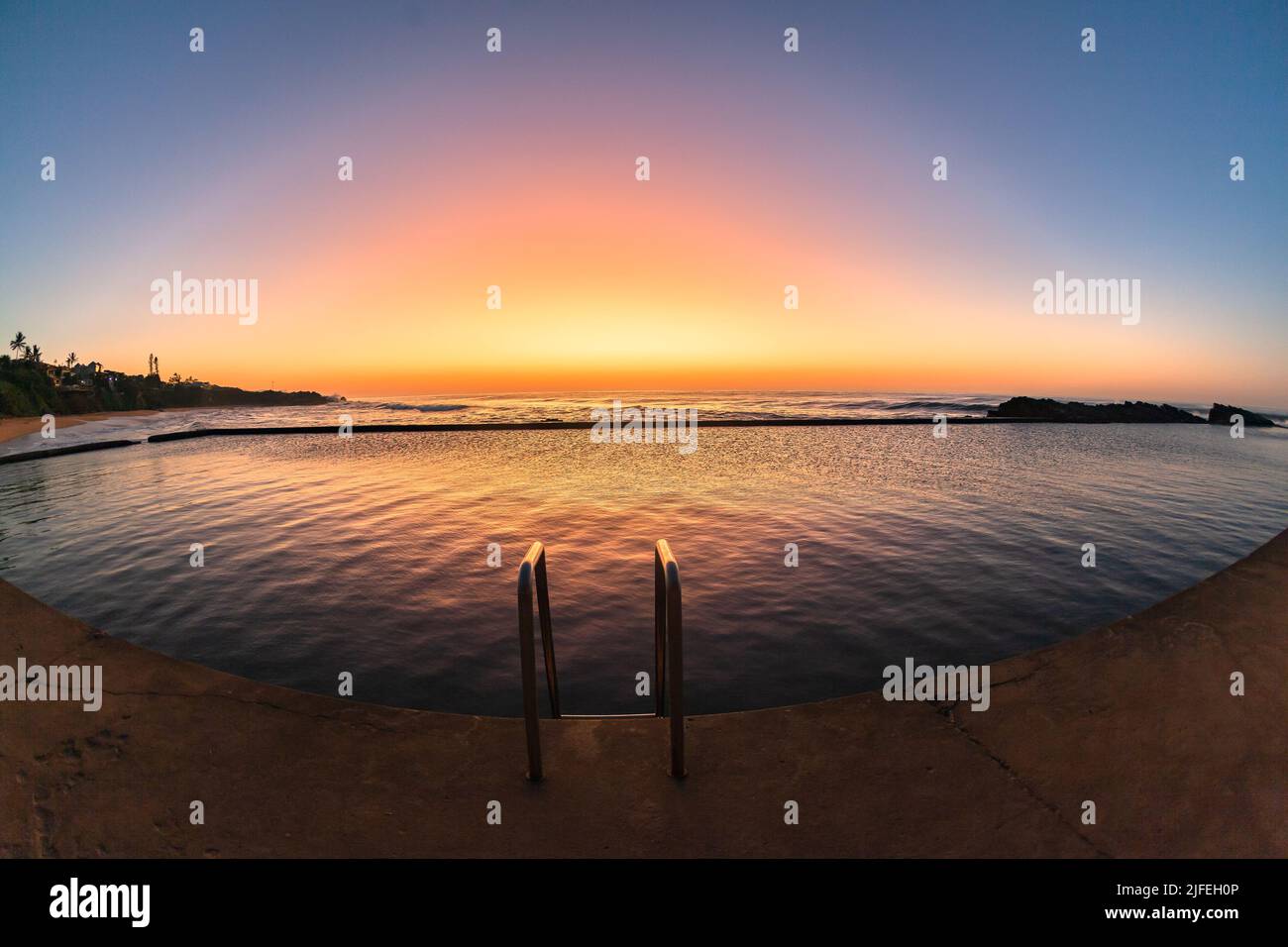 Beach ocean sea horizon morning dawn light color reflections in sky and ...